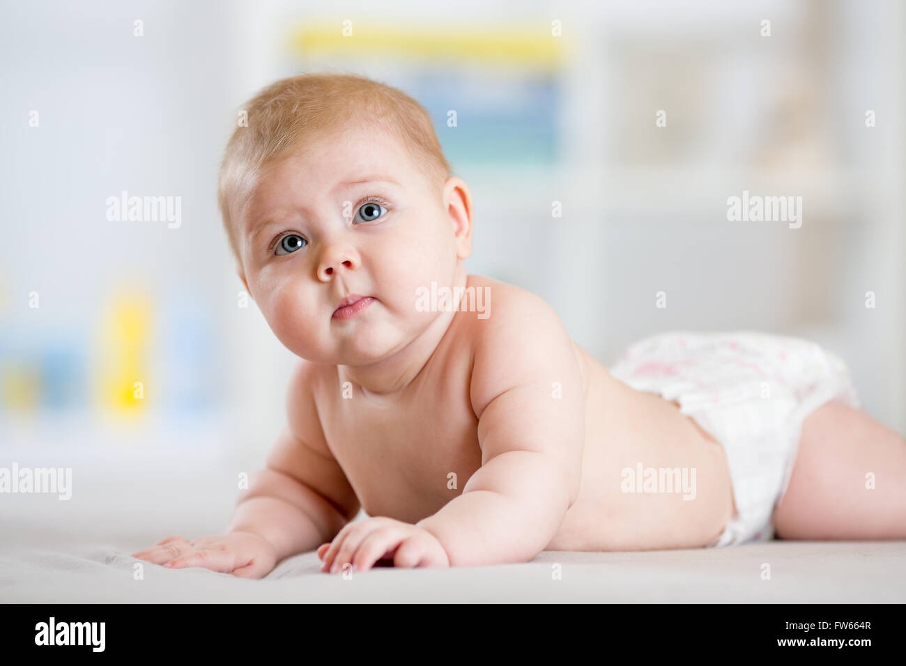 Portrait of baby girl lying on bed hi-res stock photography and images - Alamy