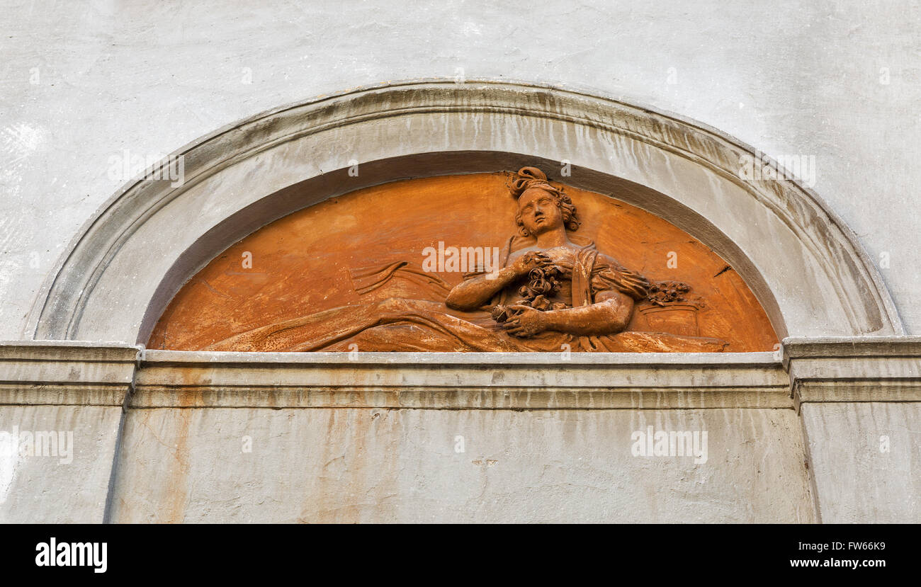 Ancient bas relief of woman with flowers on building wall in Graz ...