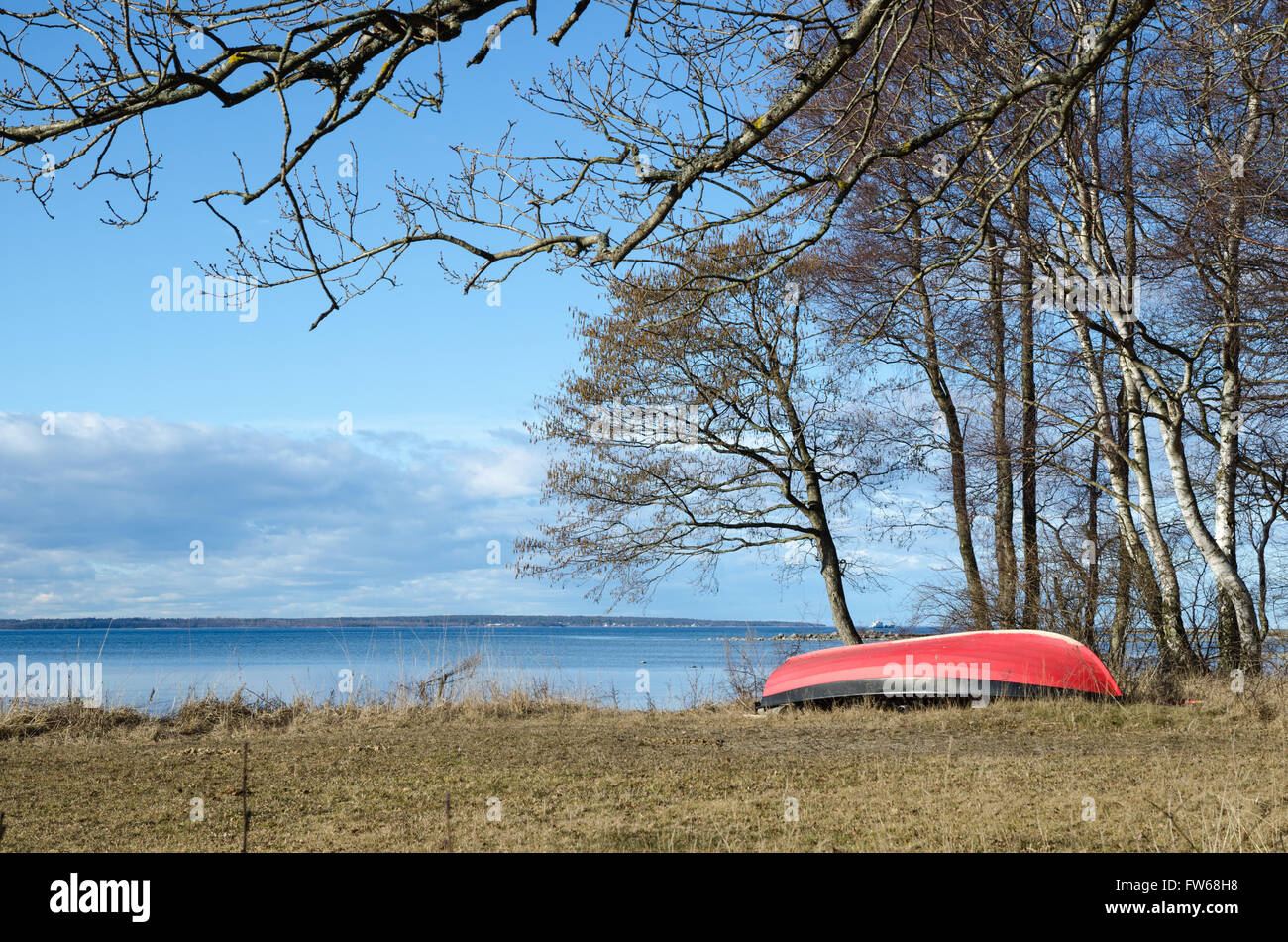 Coastal spring season view with a small rowing boat up side down on ...