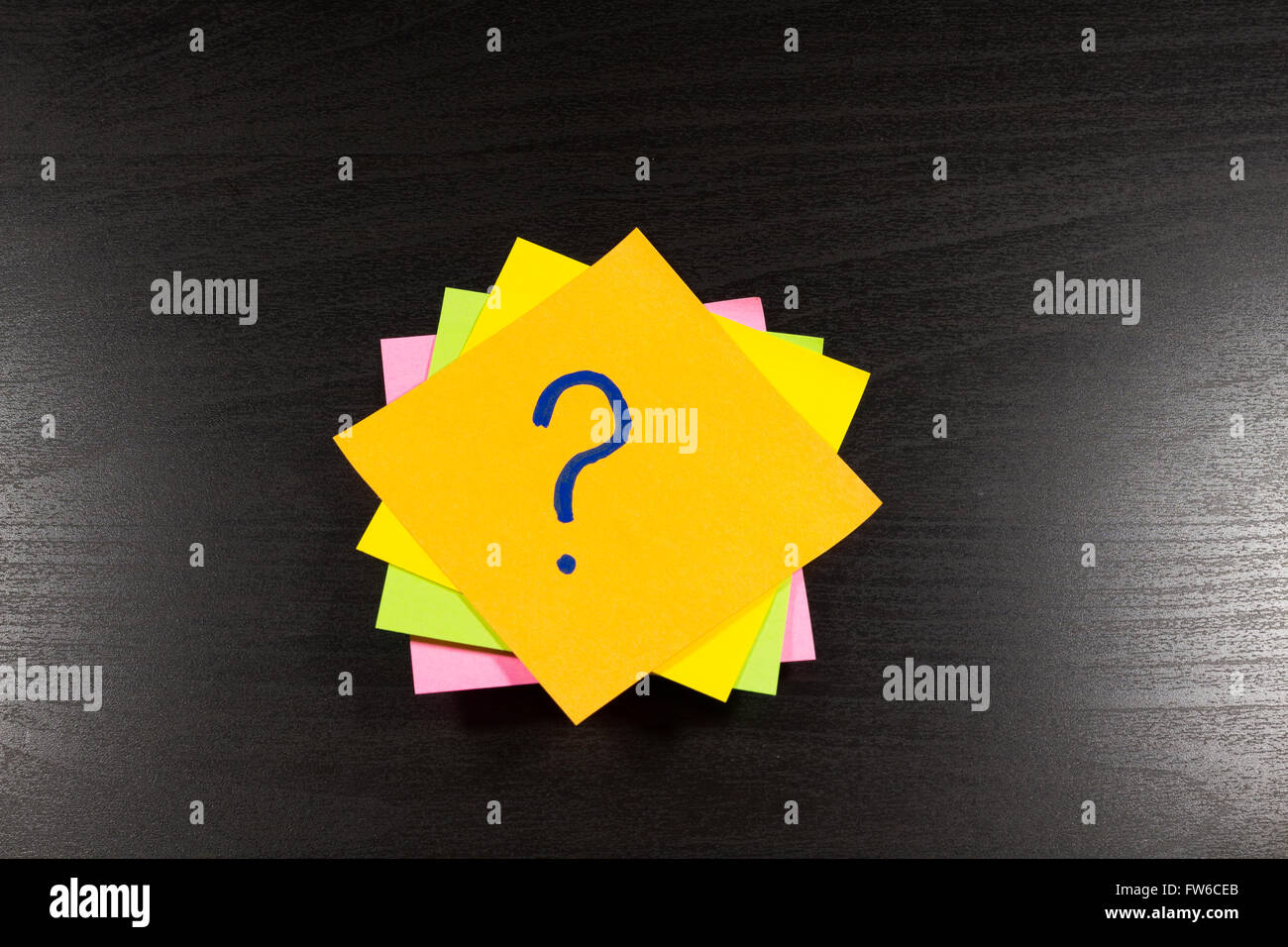 question mark on a sticky note on wooden background Stock Photo - Alamy