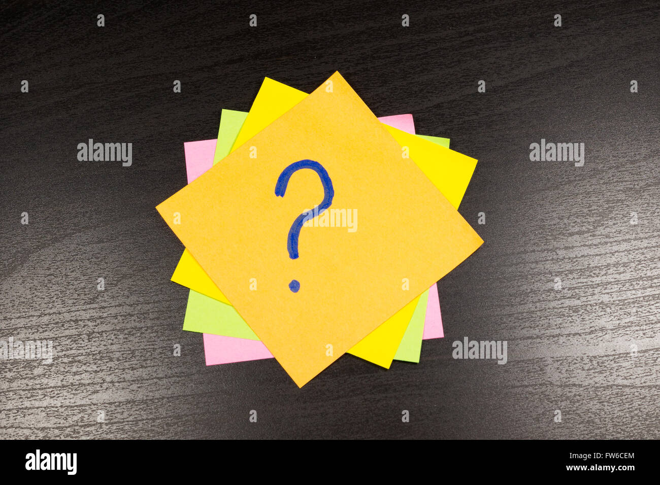 question mark on a sticky note on wooden background Stock Photo - Alamy