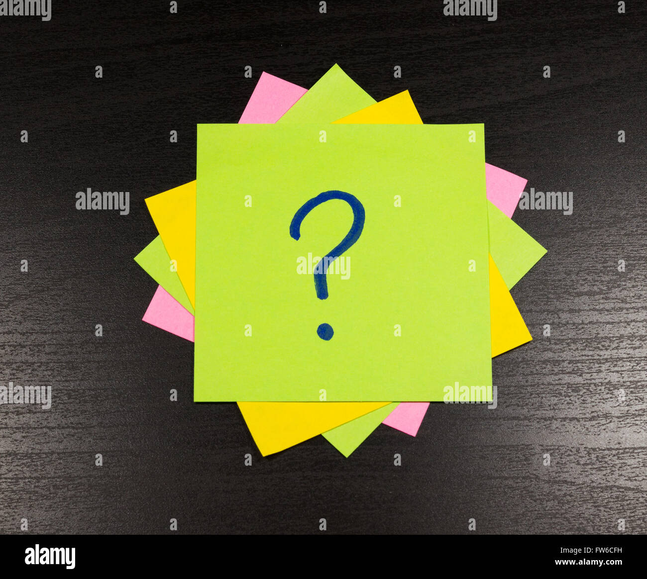 question mark on a sticky note on wooden background Stock Photo - Alamy