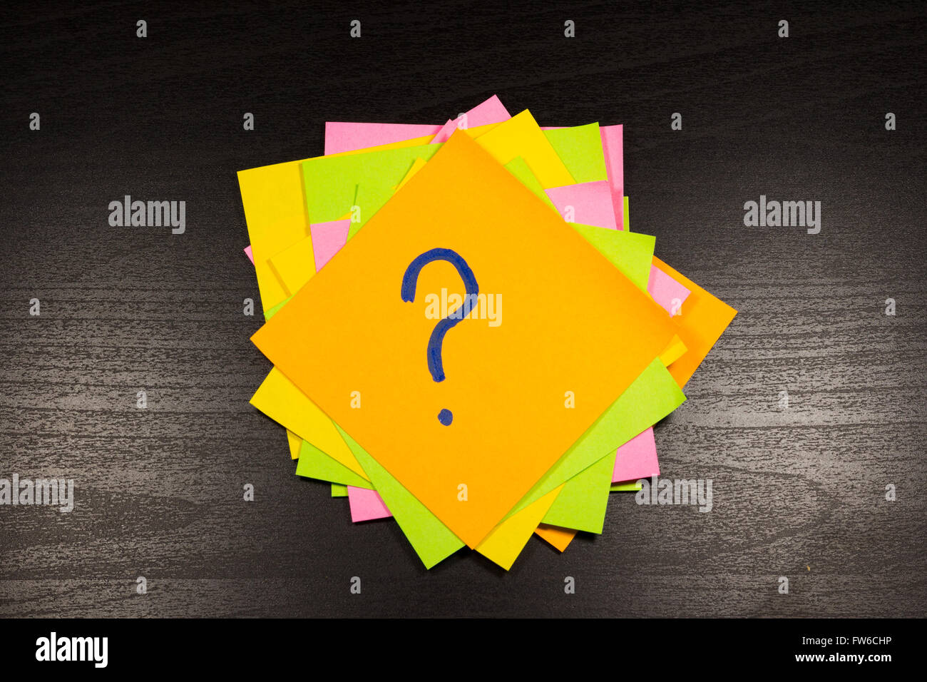 question mark on a sticky note on wooden background Stock Photo - Alamy