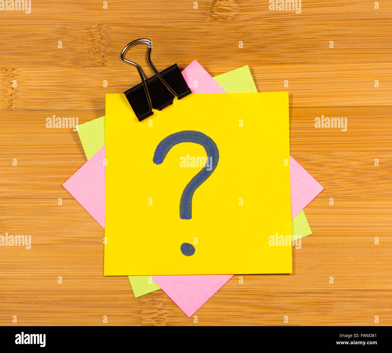 question mark on a sticky note on wooden background Stock Photo - Alamy