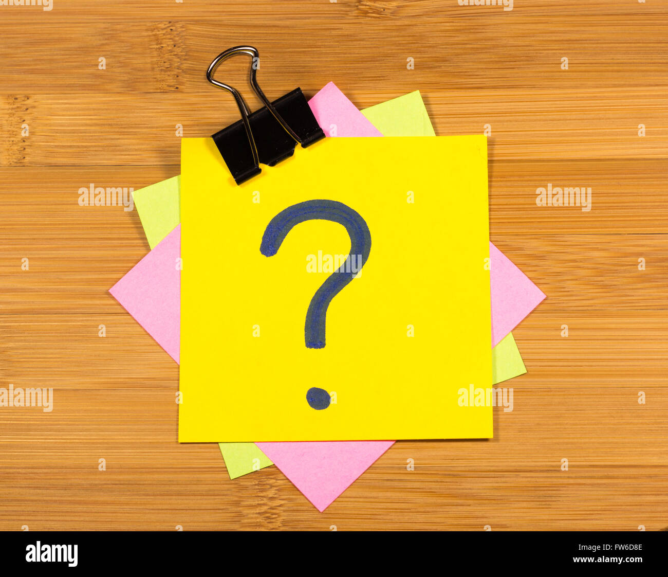 question mark on a sticky note on wooden background Stock Photo - Alamy