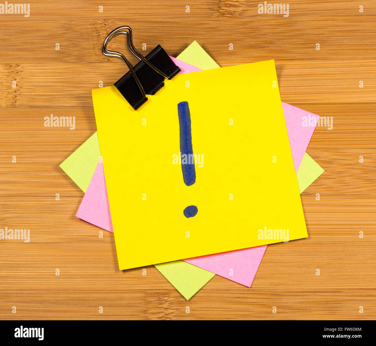 exclamation mark on a sticky note on wooden background Stock Photo - Alamy