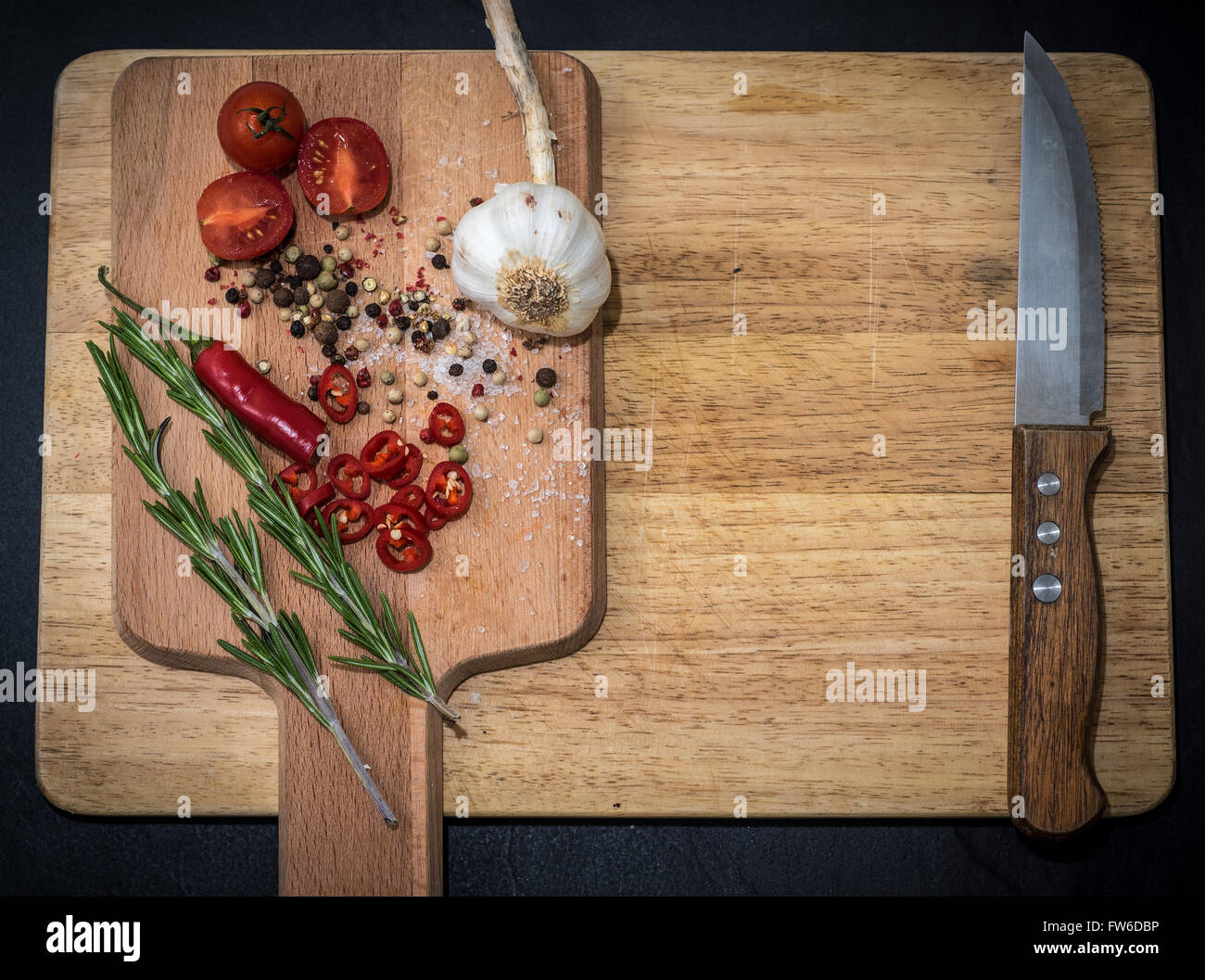 Rustic wooden chopping board background red chili peppers,vine tomato ...
