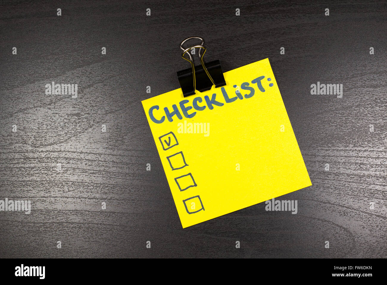 checklist sticky note on wooden background Stock Photo - Alamy
