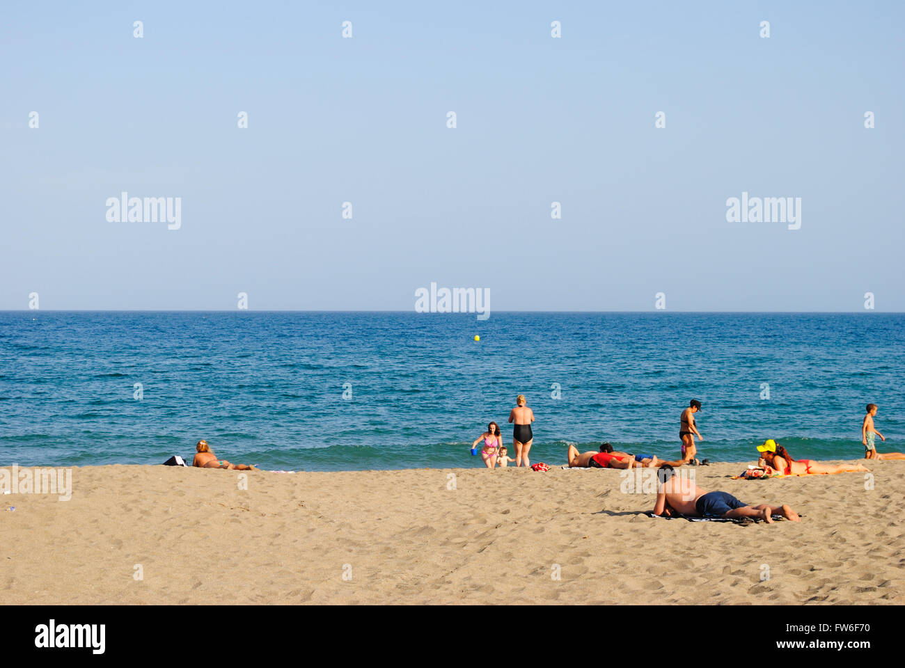 People enjoying the sun on Fuengirola beach Stock Photo - Alamy