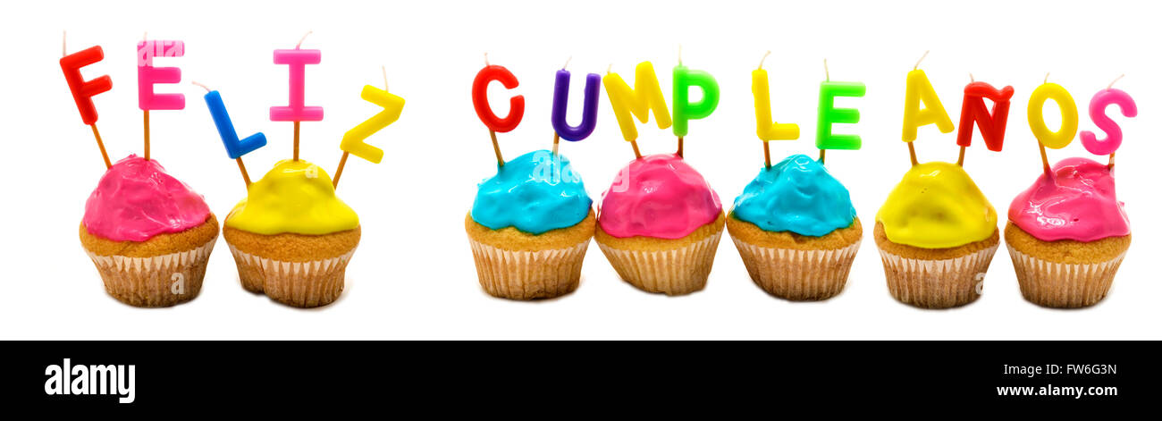 Birthday cupcakes with candles happy birthday in Spanish Stock Photo ...