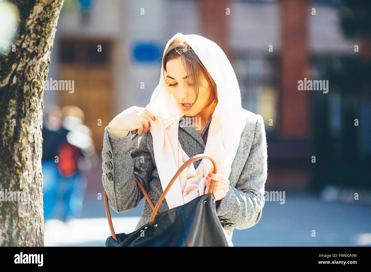 girl looking for something in a bag Stock Photo - Alamy