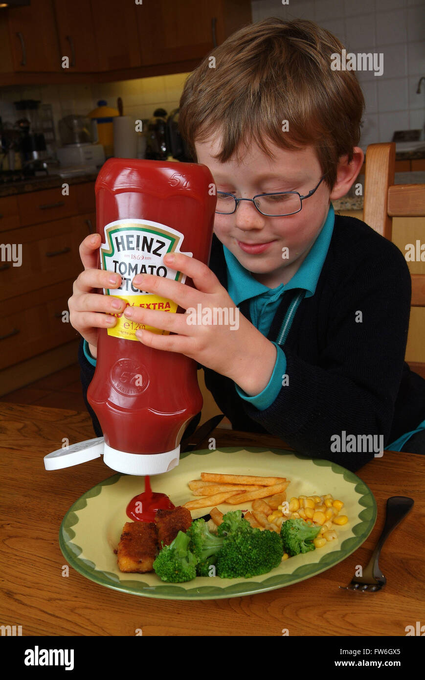Young boys using Heinz tomato ketchup Stock Photo - Alamy