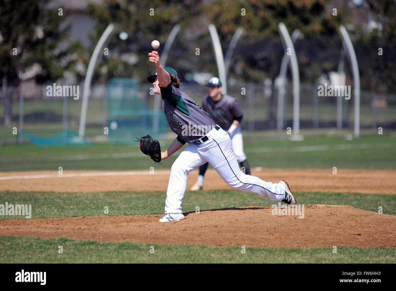 Pitcher releasing a pitch during a high school baseball game. USA Stock ...