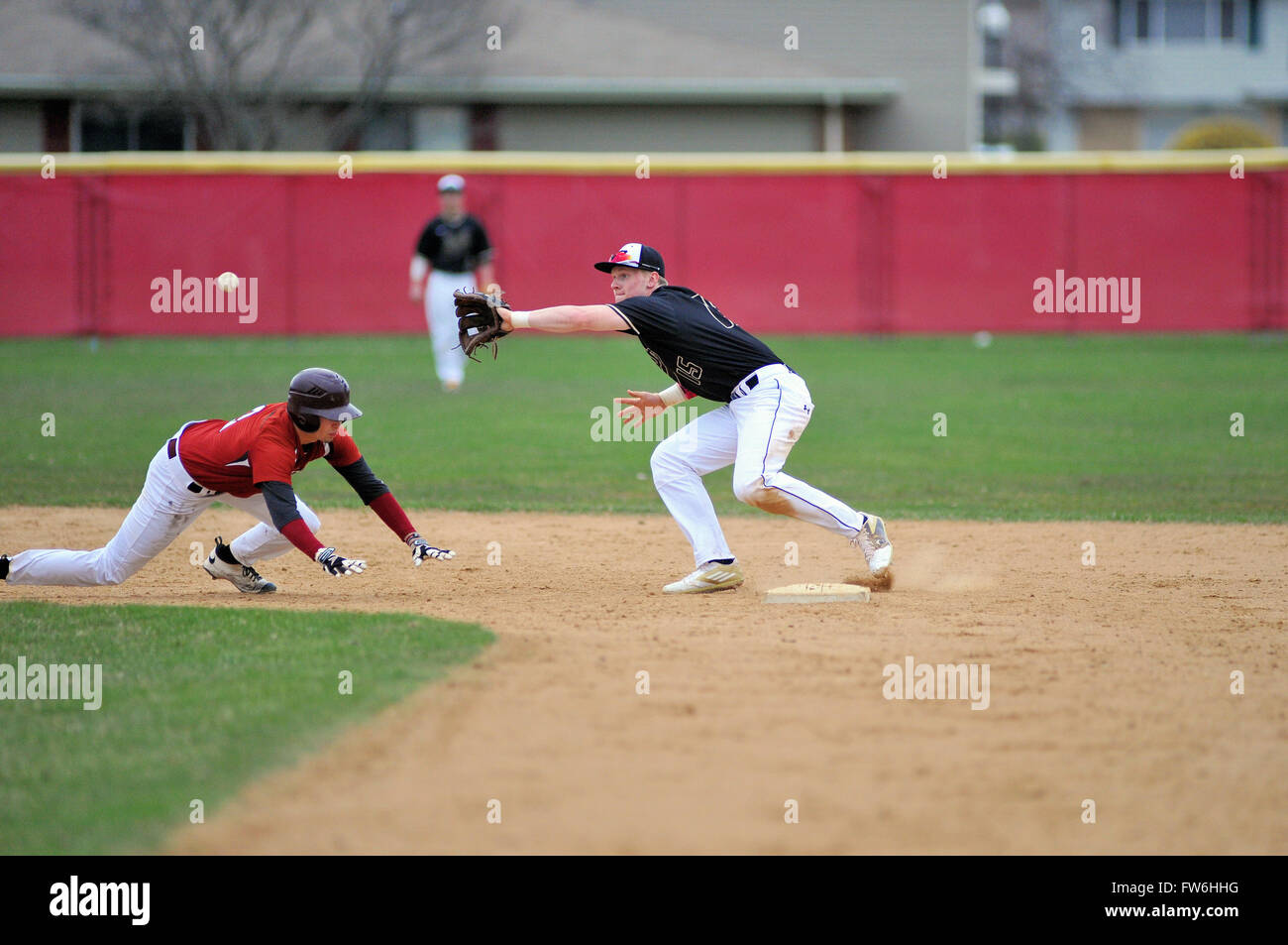 A shortstop cutting in behind a runner in successfully executing a pick ...