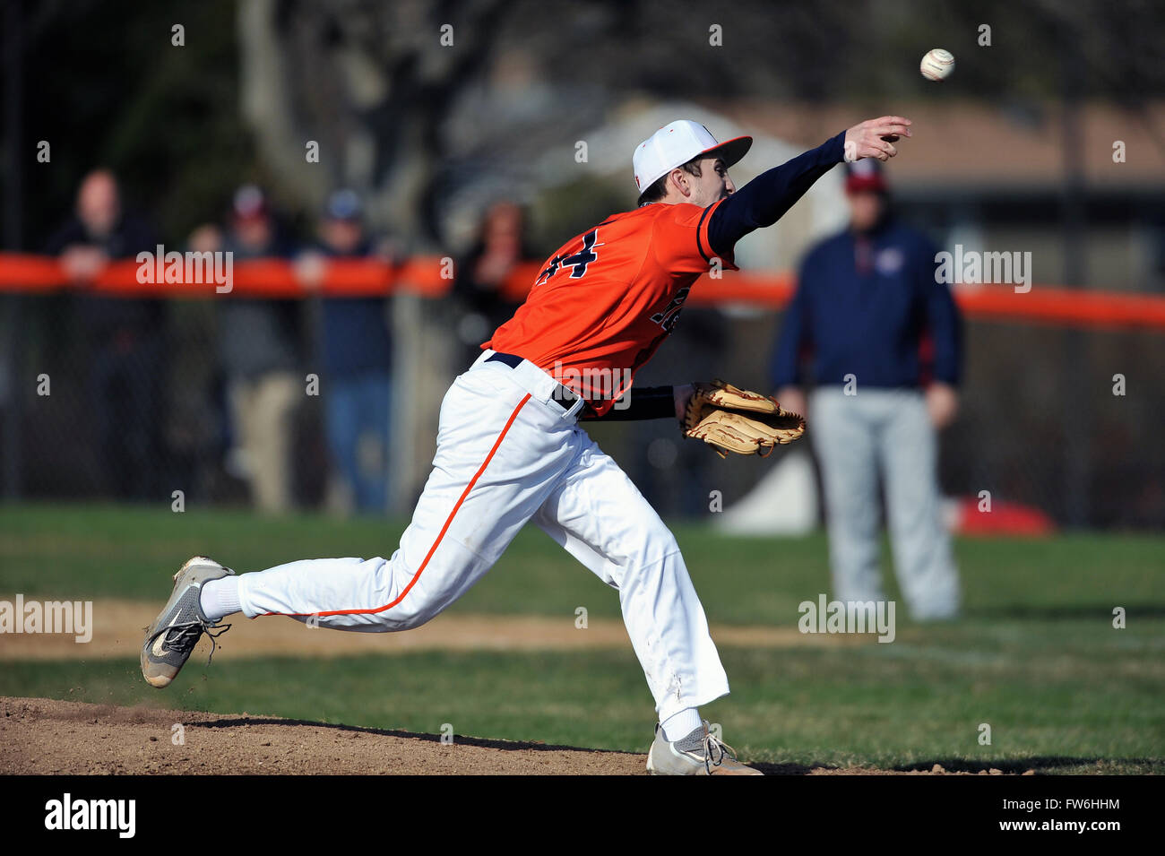 Pitcher releasing a pitch during an early spring high school non ...