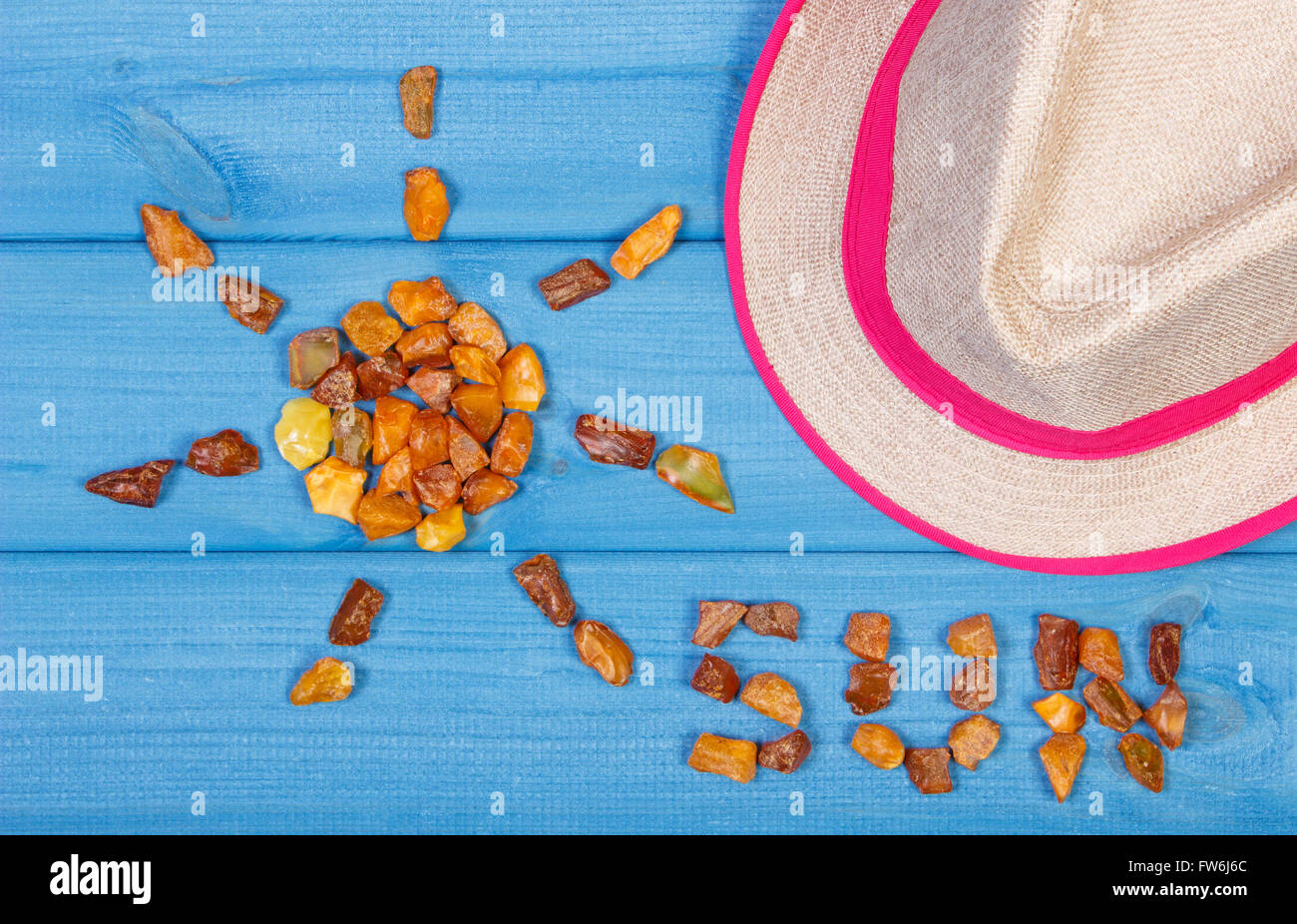 Shape of sun with word sun made of amber stones and straw hat for ...