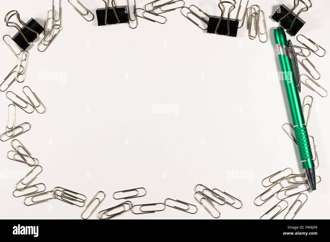 Notebook with blank paper, color sticky notes, pen and clips on a ...