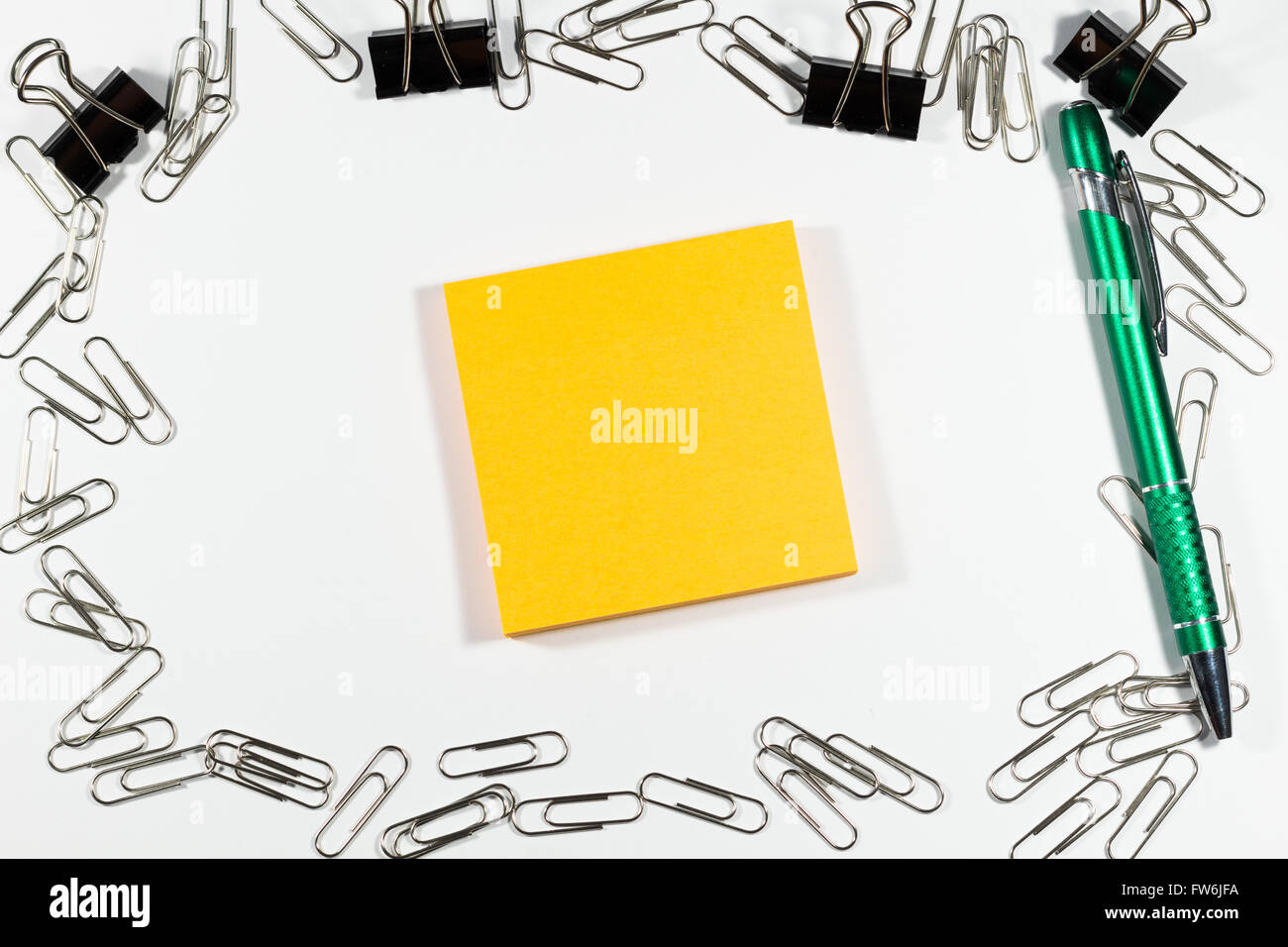 Notebook with blank paper, color sticky notes, pen and clips on a ...