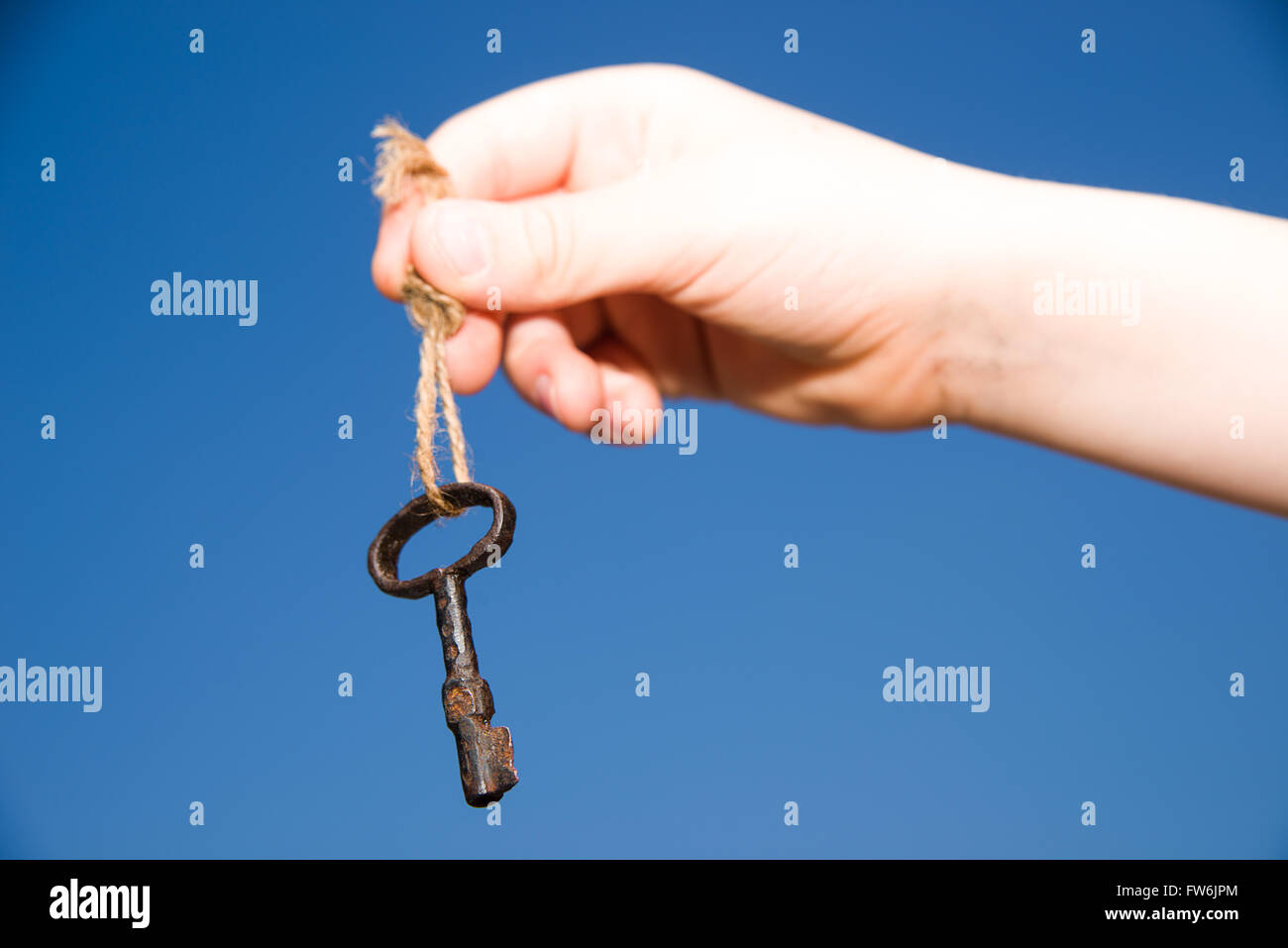 Child hand holding an old key on a string against the sky Stock Photo ...