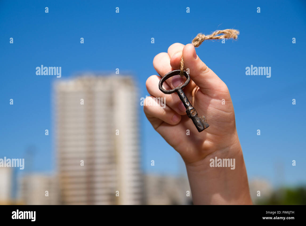 Child hand holding an old key on a string against the sky Stock Photo ...