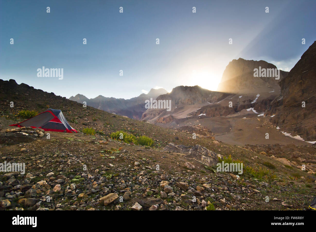 yellow sunrise above mountain rocks with sun crown and blue sky Stock ...