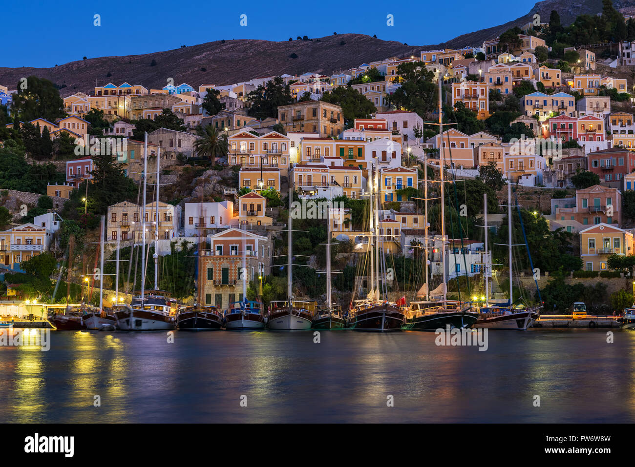 Colorful greek traditional houses in Symi island at night Stock Photo ...
