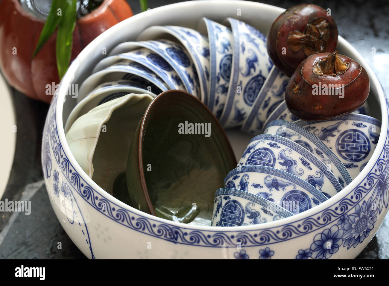 A pot of tea cups and two water chestnut Stock Photo - Alamy