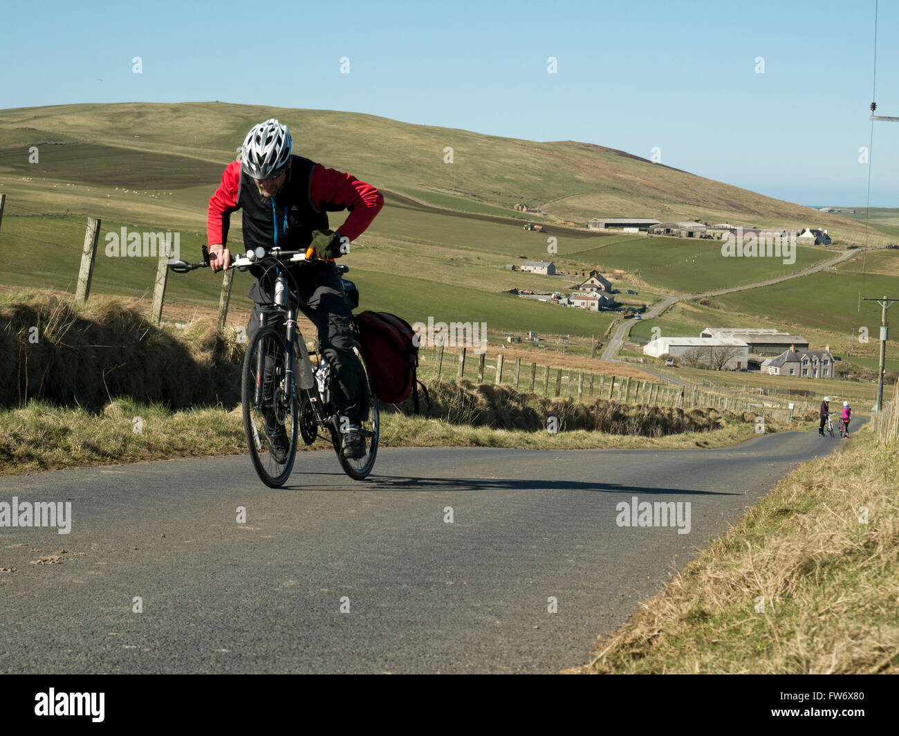 Struggling to cycle uphill Stock Photo - Alamy