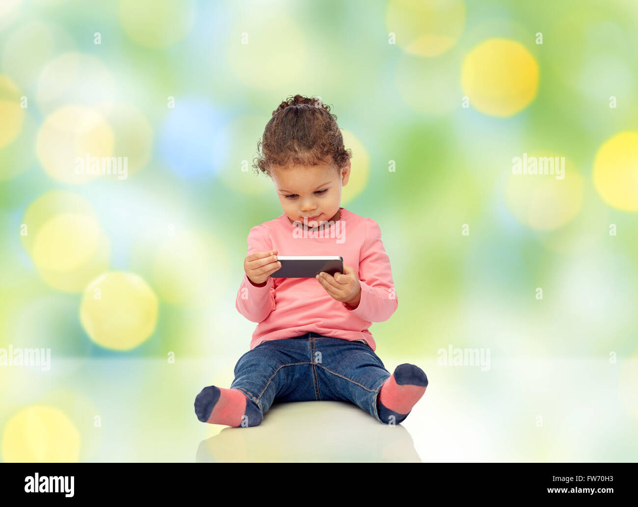 smiling little baby girl playing with smartphone Stock Photo - Alamy