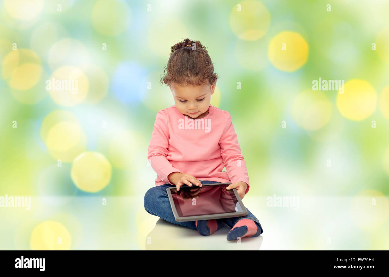 little baby girl playing with tablet pc computer Stock Photo - Alamy