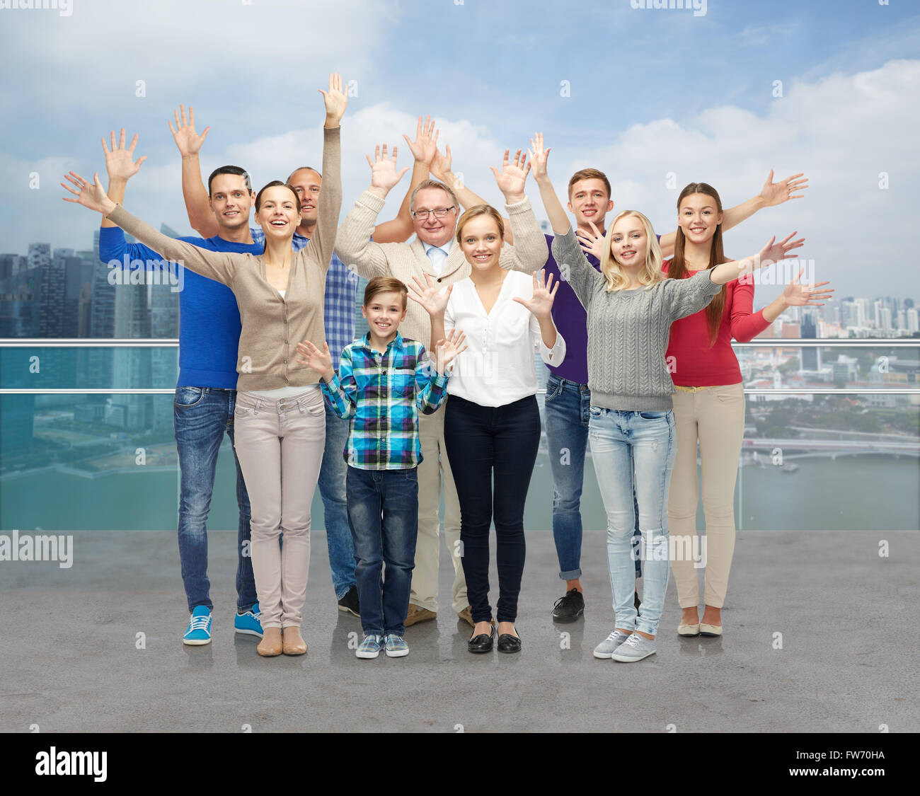 group of smiling people waving hands Stock Photo - Alamy