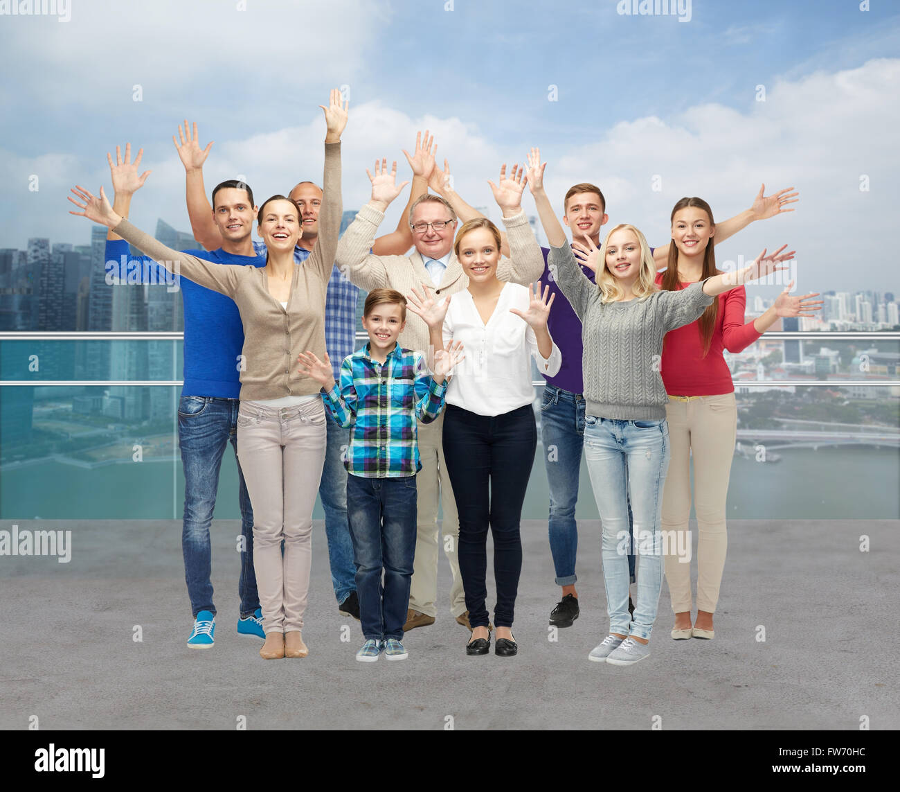 group of smiling people waving hands Stock Photo - Alamy