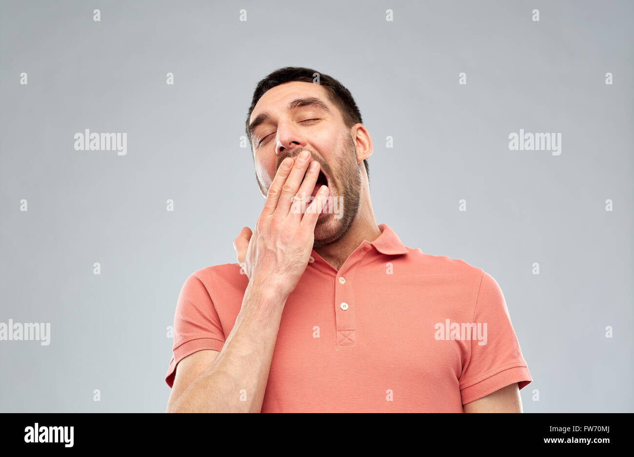 yawning man over gray background Stock Photo - Alamy