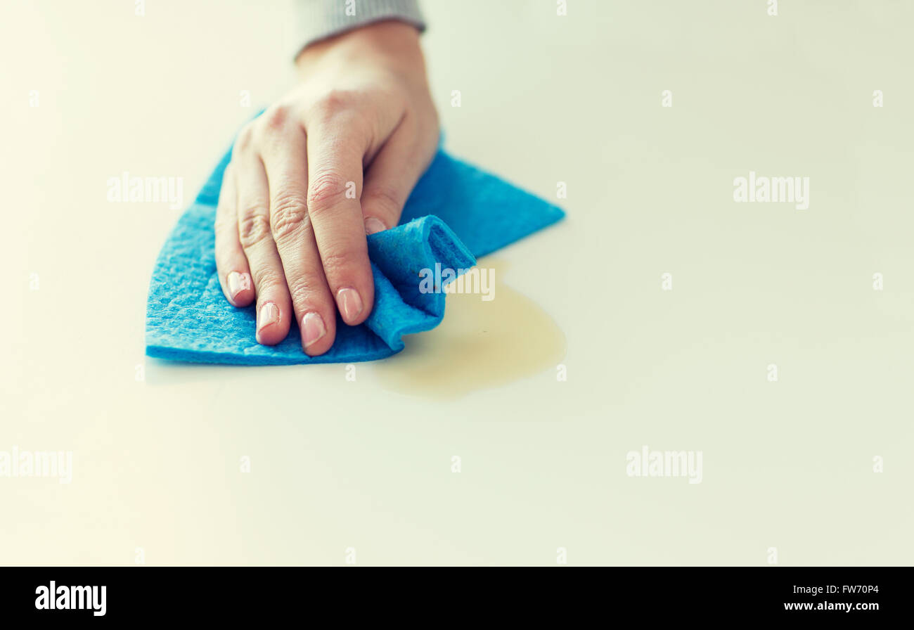 close up of hand cleaning table surface with cloth Stock Photo - Alamy