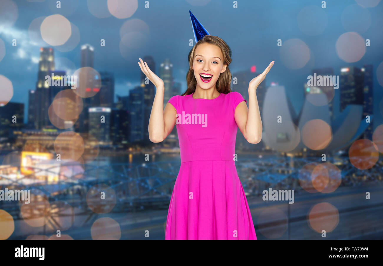 happy young woman or teen girl in party cap Stock Photo - Alamy