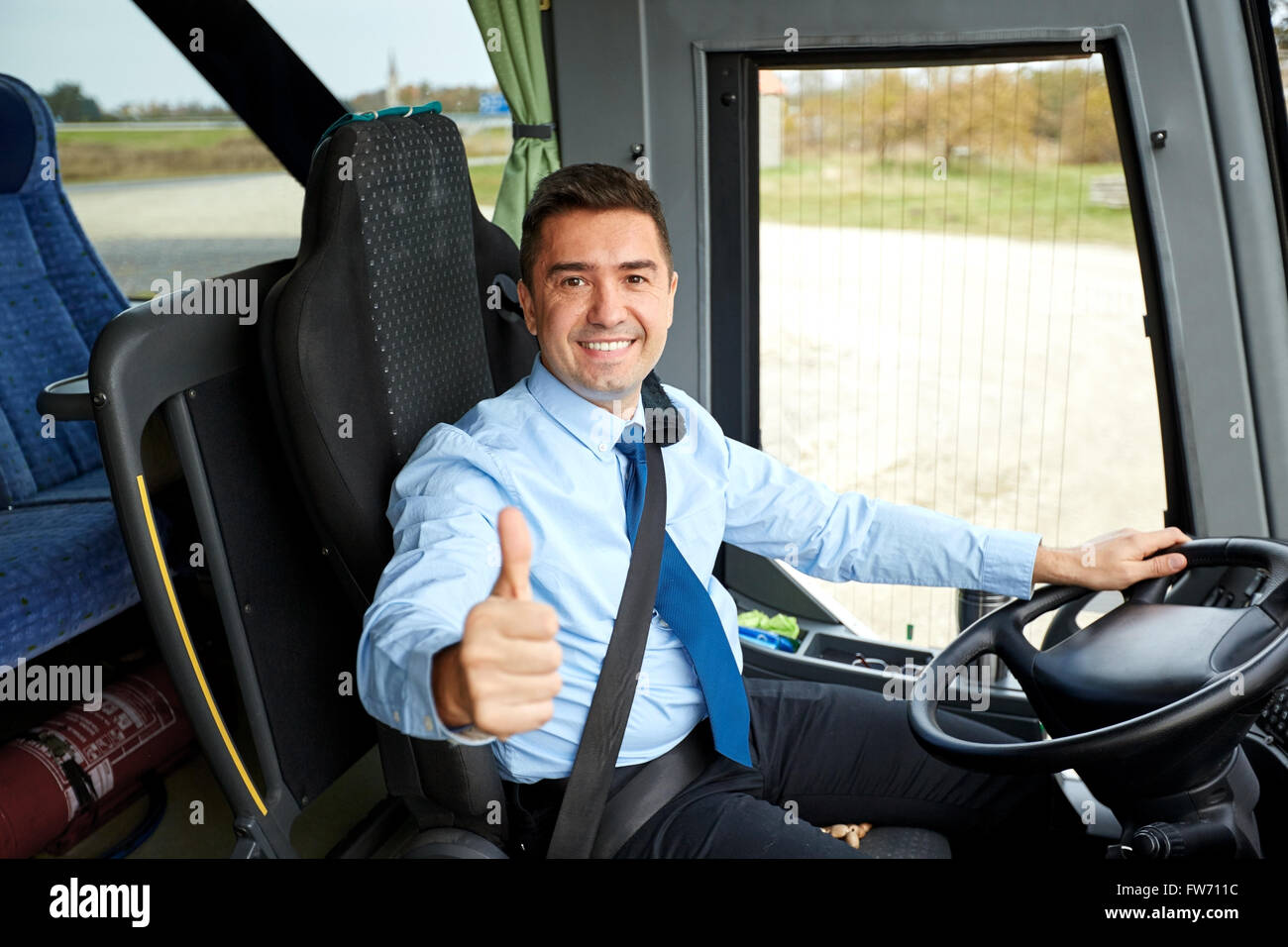 happy driver driving bus and snowing thumbs up Stock Photo - Alamy
