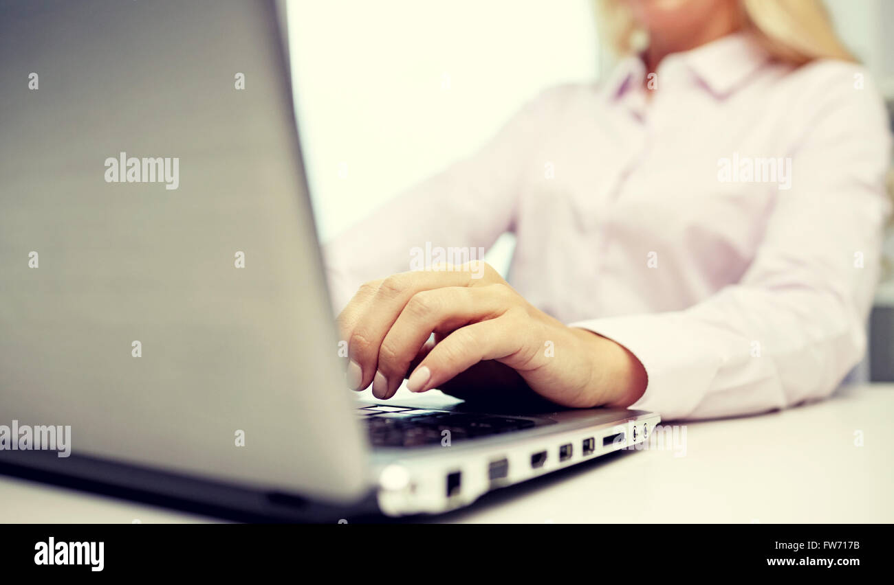 smiling businesswoman or student typing on laptop Stock Photo - Alamy