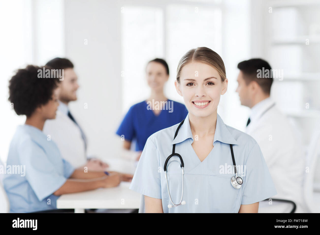 happy doctor over group of medics at hospital Stock Photo - Alamy