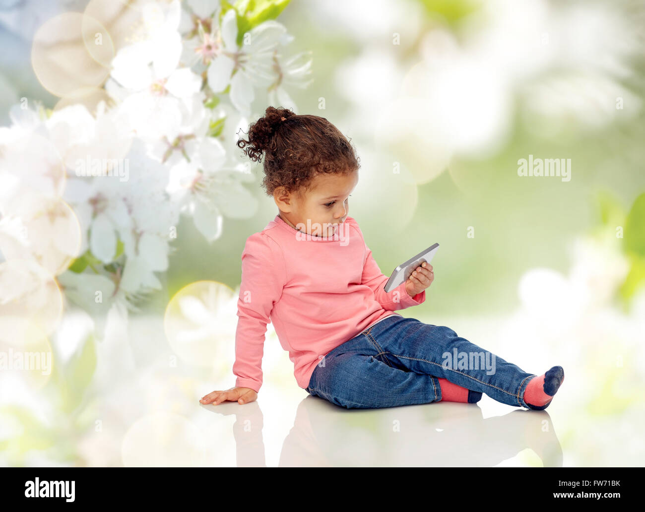 smiling little baby girl playing with smartphone Stock Photo - Alamy