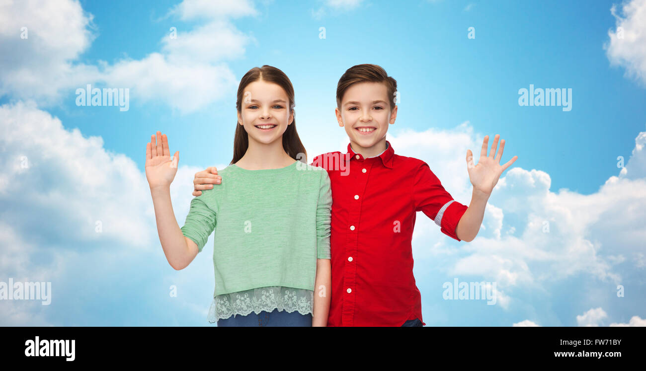 happy boy and girl waving hand Stock Photo - Alamy