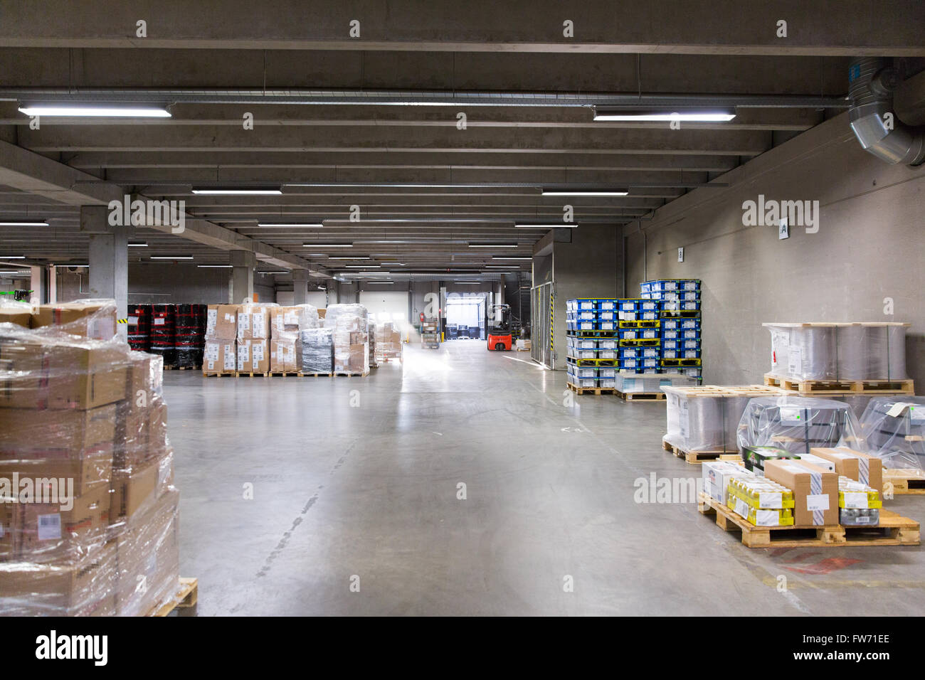 forklift loader and boxes at warehouse Stock Photo - Alamy