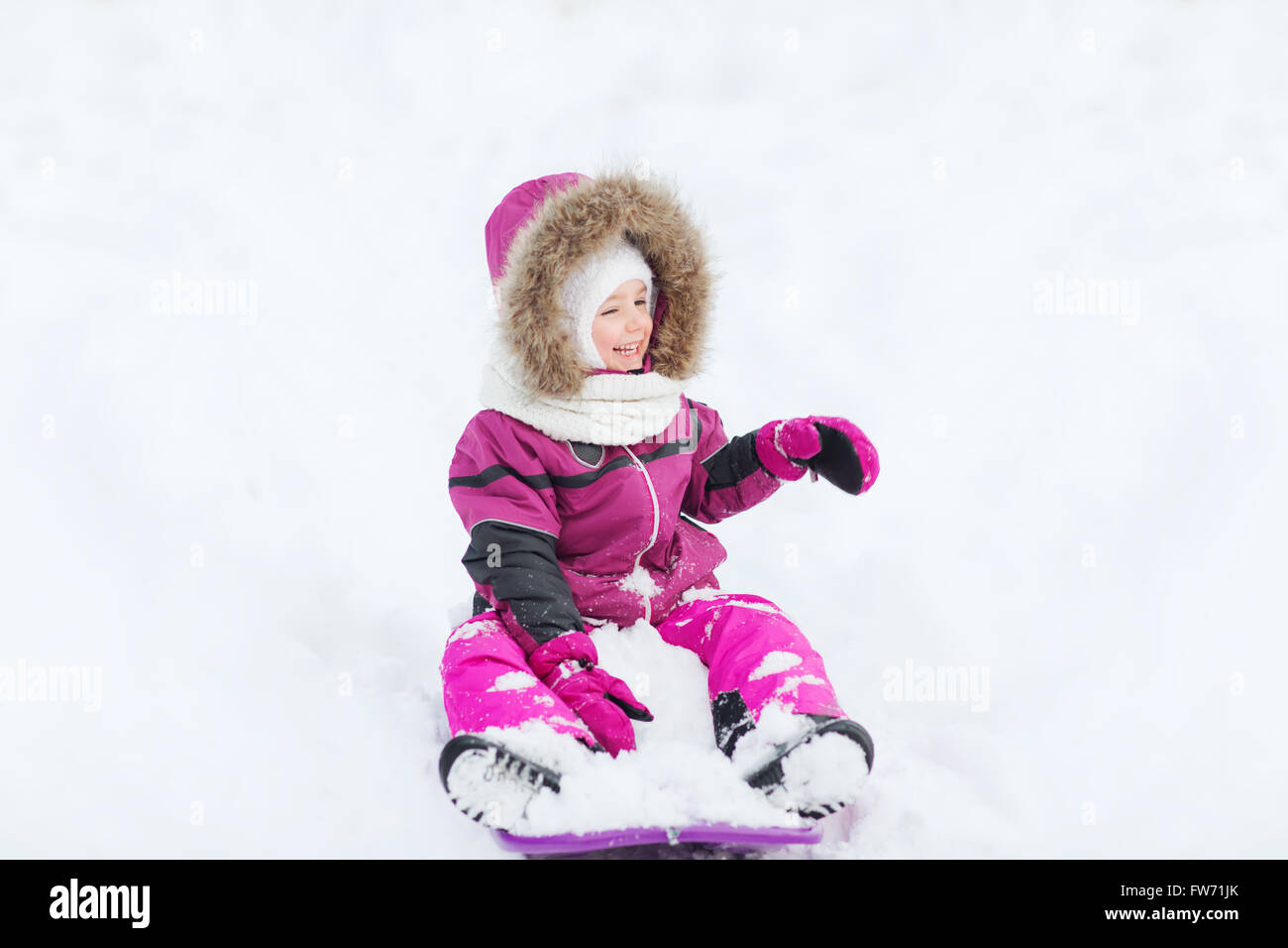happy little kid on sled outdoors in winter Stock Photo - Alamy