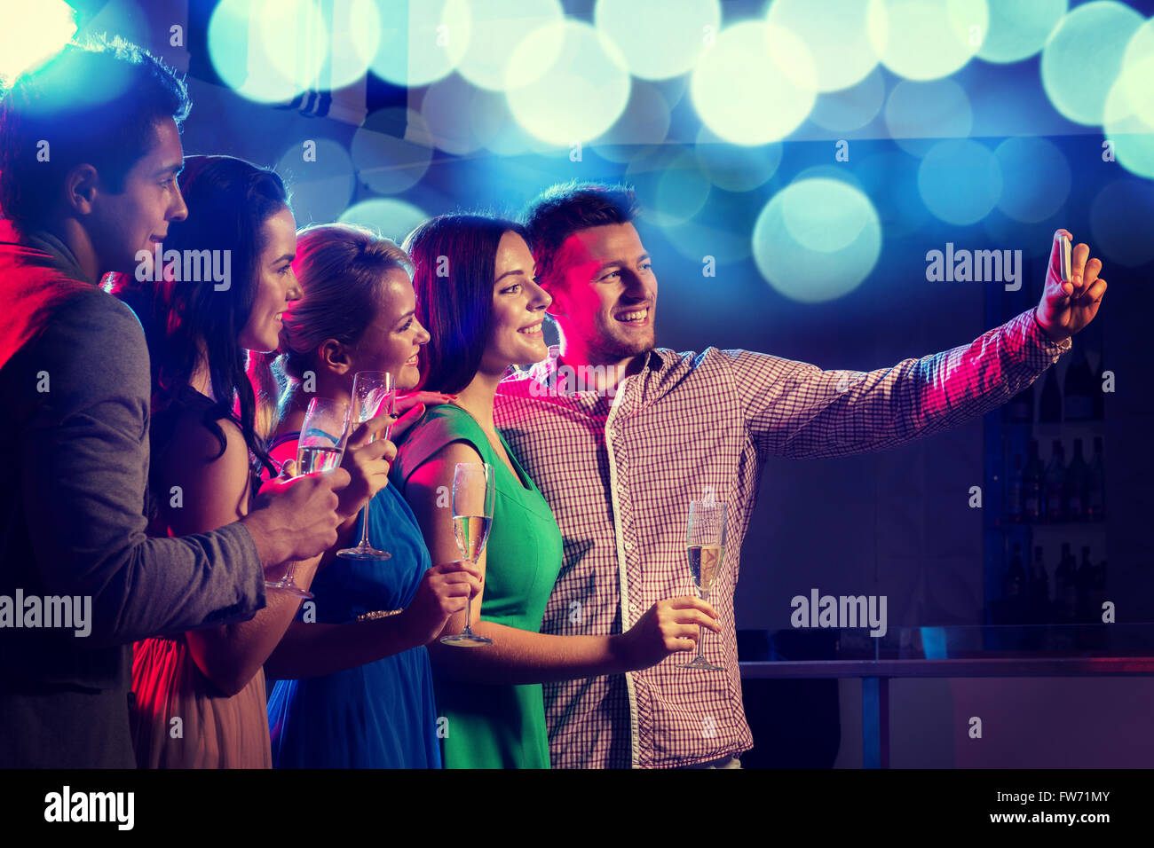 friends with glasses and smartphone in club Stock Photo - Alamy