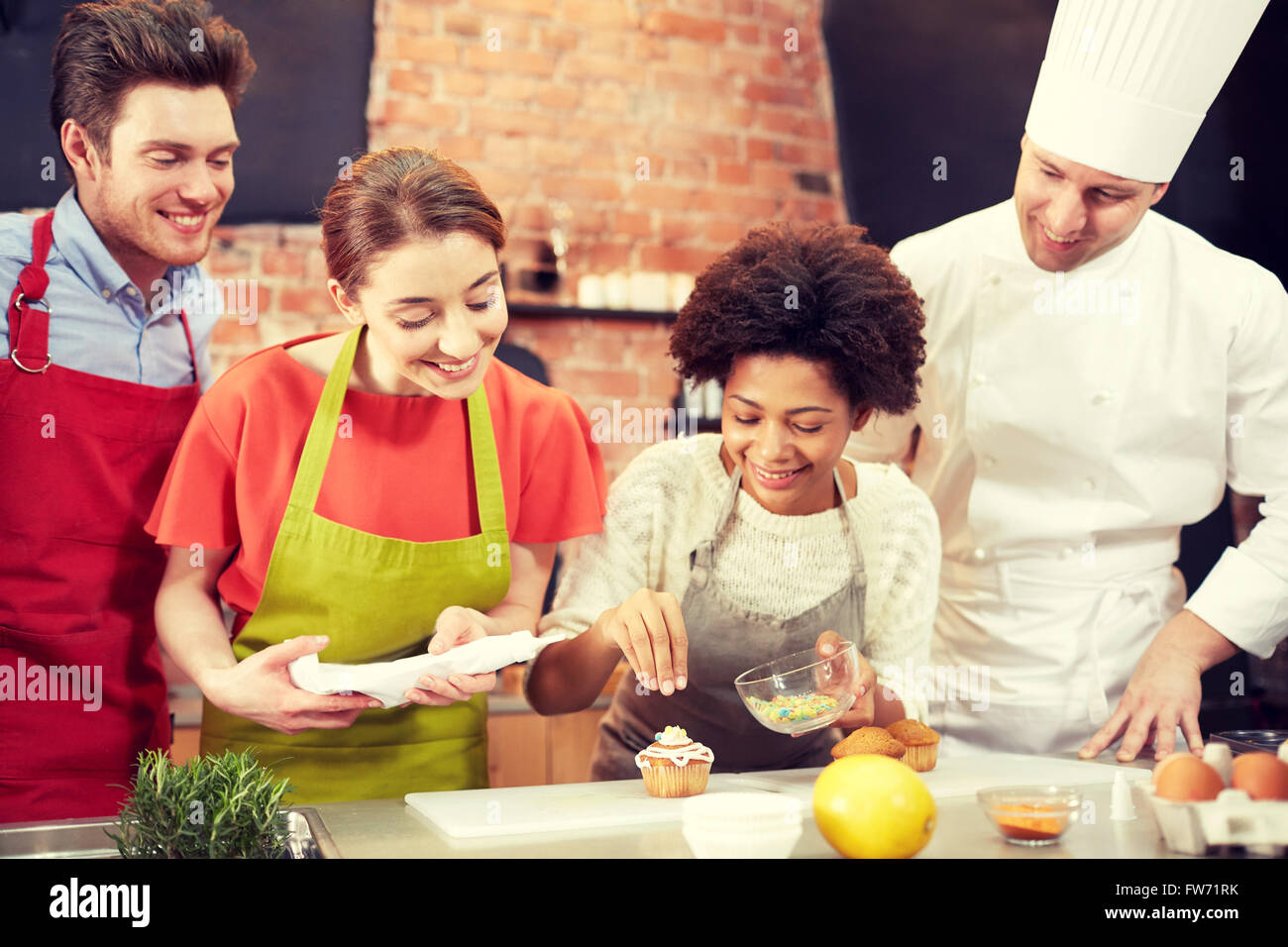 happy friends and chef cook baking in kitchen Stock Photo - Alamy