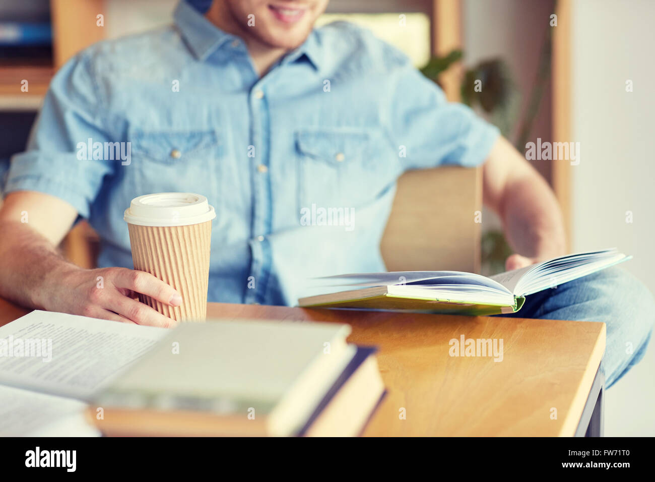 happy student reading book and drinking coffee Stock Photo - Alamy