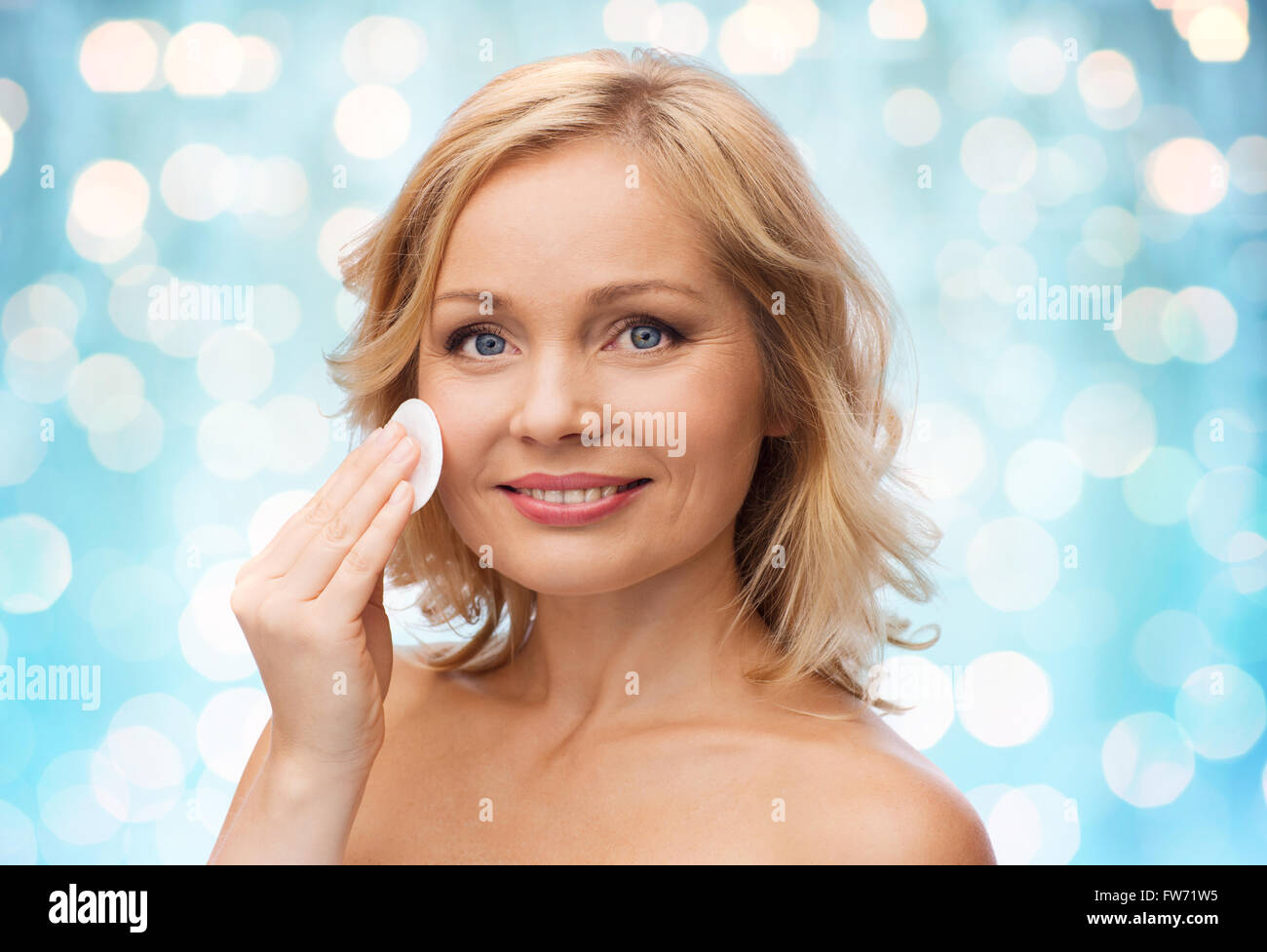 happy woman cleaning face with cotton pad Stock Photo - Alamy