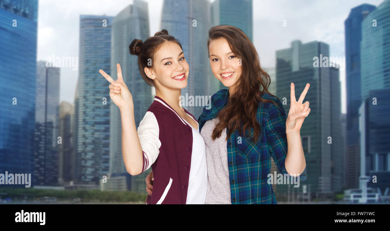 happy teenage girls hugging and showing peace sign Stock Photo - Alamy