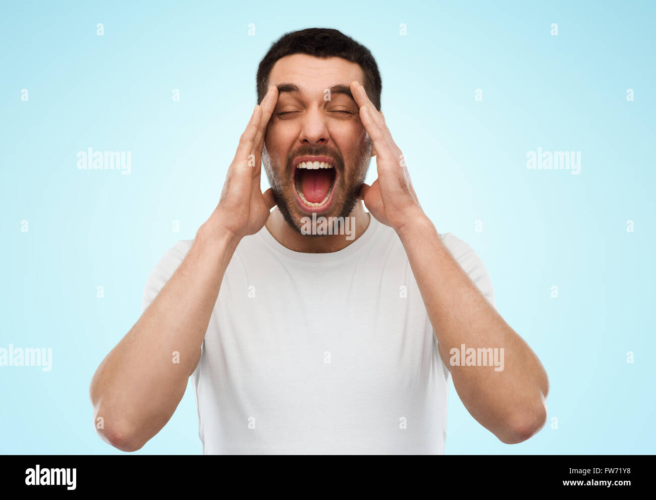 crazy shouting man in t-shirt over blue background Stock Photo - Alamy