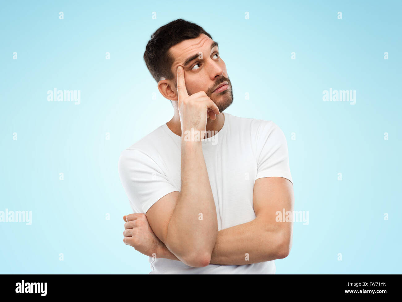 man thinking over blue background Stock Photo - Alamy