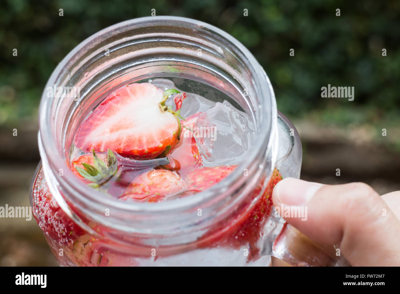 Hand hold glass of iced strawberry soda drink, stock photo Stock Photo ...
